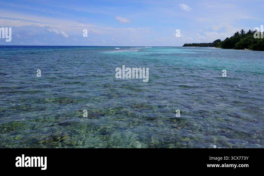 Warm scenery of beautiful island beach vacation by shallow water with ...