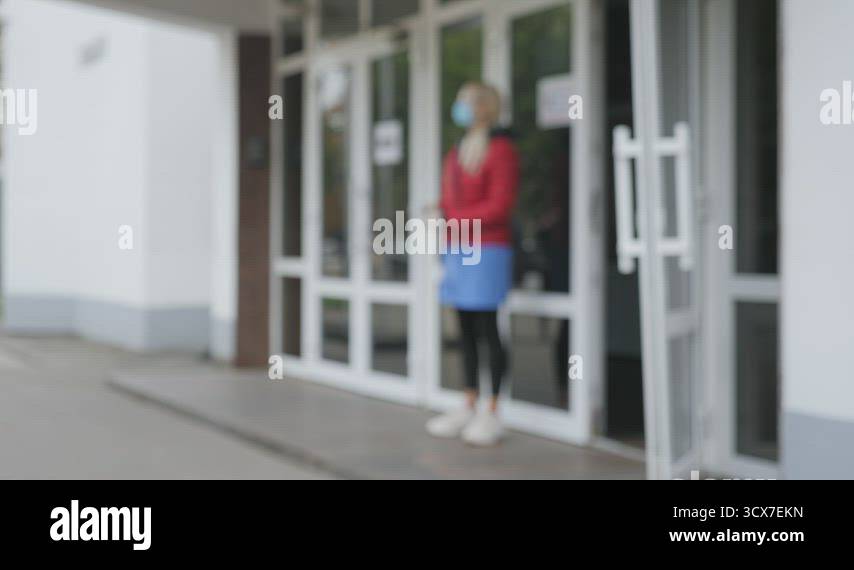 Blurry View of Medical worker remote checks temperature of people at ...