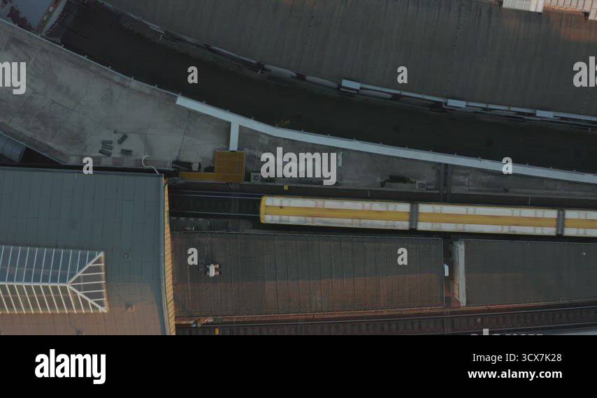 Yellow Train entering Subway Station elevated above ground in Berlin ...