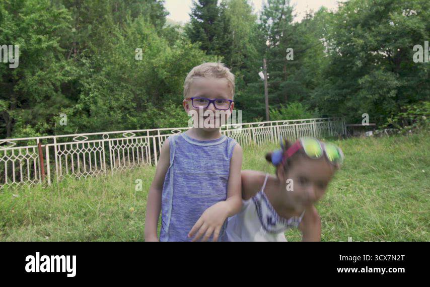 Two little kids jumping and fooling around. Young cute careless ...