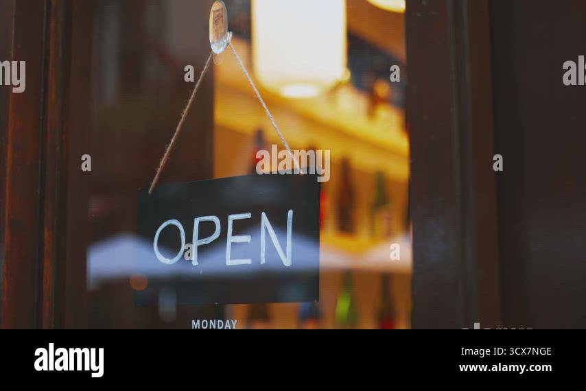 Close up view of an Open sign hanging on the glass door of a Japanese ...