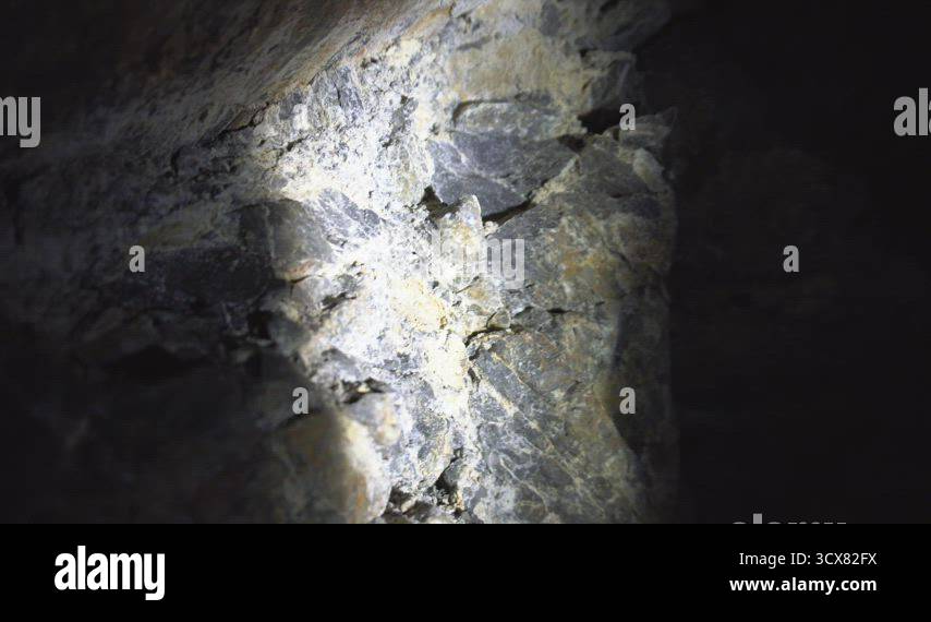 Light from a flashlight in the cave wall Stock Video Footage - Alamy