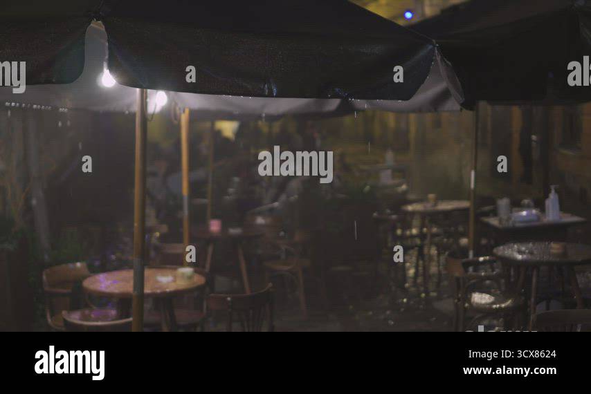 Nightlife in the rain. Raining night at the outdoor old town street ...