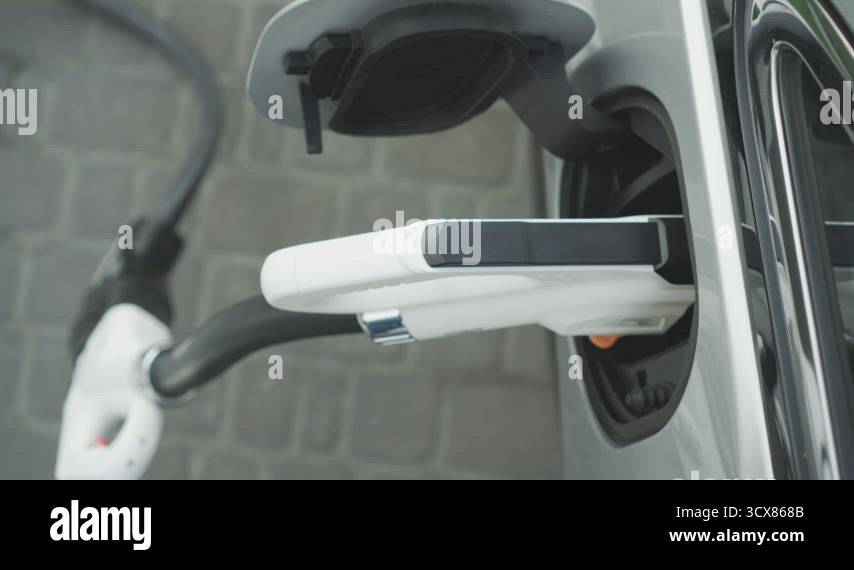 Caucasian man hand takes charger cable. Electric car vehicle with fast ...