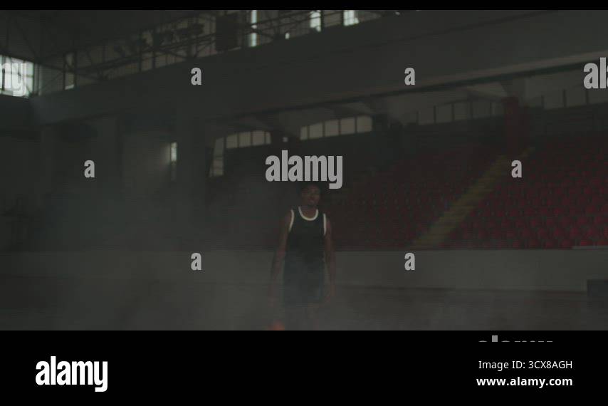 Video portrait of a basketball player bouncing a ball. African american ...