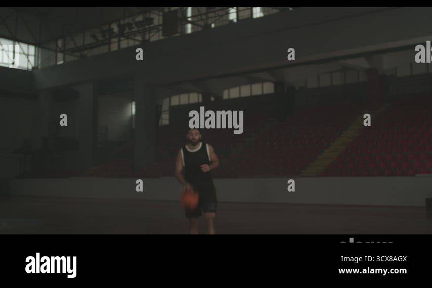 Video portrait of a basketball player bouncing a ball. Caucasian man in ...