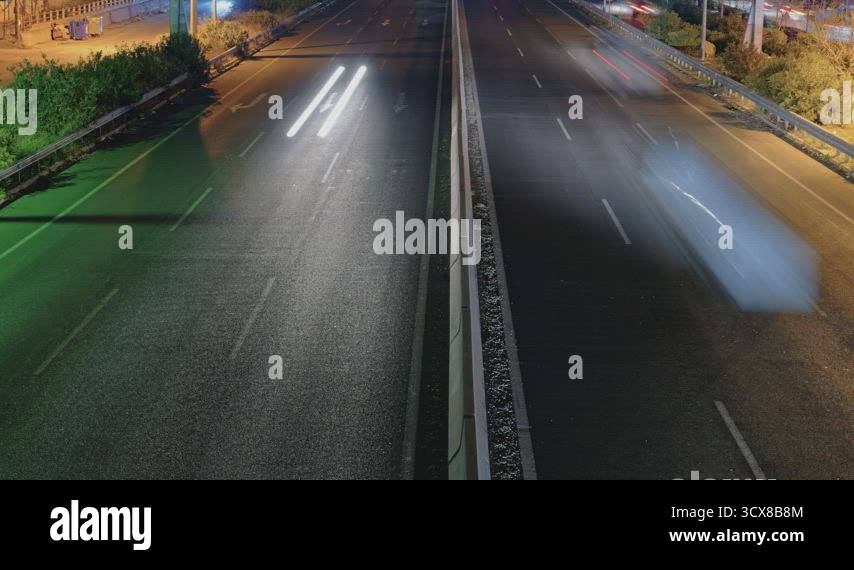 Elevated traffic time lapse on a highway separated by a median Stock ...