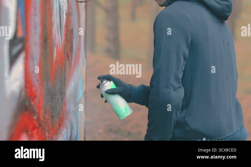Youthful Guy Drawing Graffiti Using Spray Paint Can Stock Video Footage ...