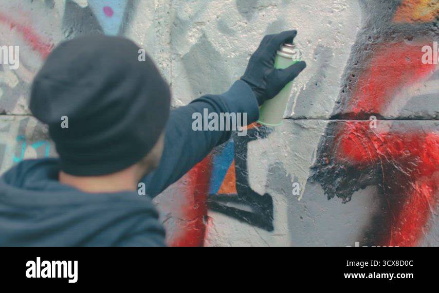 Youthful Guy Drawing Graffiti Using Spray Paint Can Stock Video Footage ...