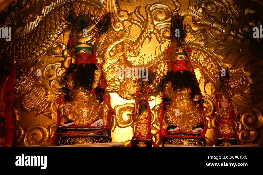 Buddhist traditional statues of chinese sacred gods on the altar inside ...