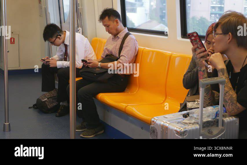 BANGKOK, THAILAND - 13 JULY, 2019: Asian passengers in train using ...