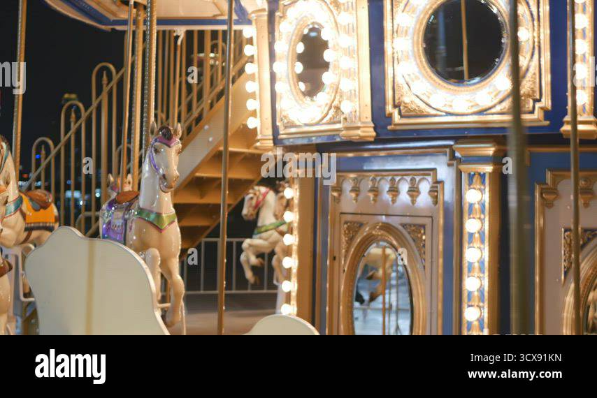 Illuminated merry go round in park. Brightly illuminated roundabout ...