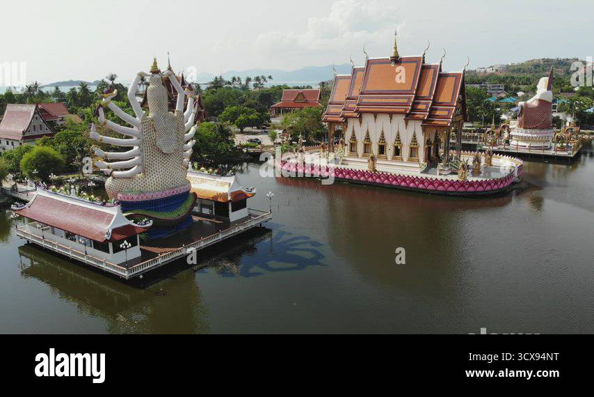 Buddhist temple near lake. Drone top view of roofs and statues of ...