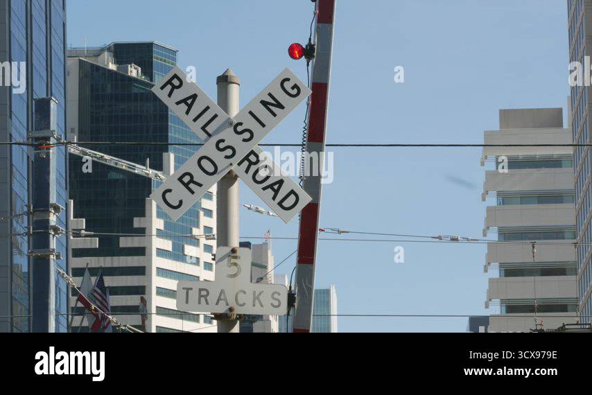 Level crossing warning signal in USA. Crossbuck notice and red traffic ...