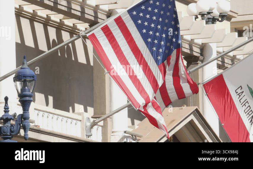 Flags of California and United States waving on flagpole in Gaslamp ...