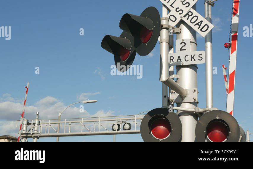 Level crossing warning signal in USA. Crossbuck notice and red traffic ...