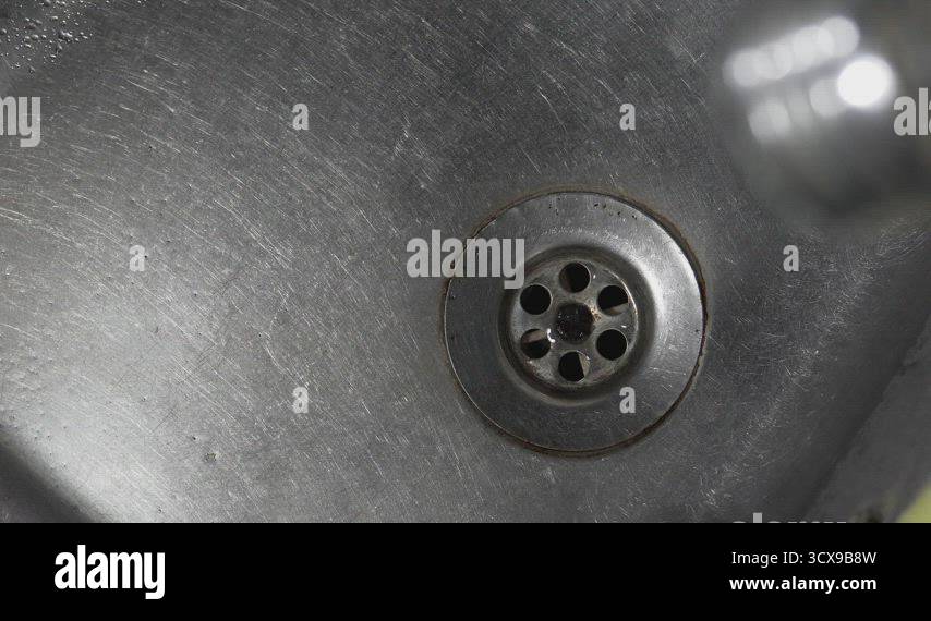 Kitchen sink drain hole and water drops dripping, background loop Stock ...