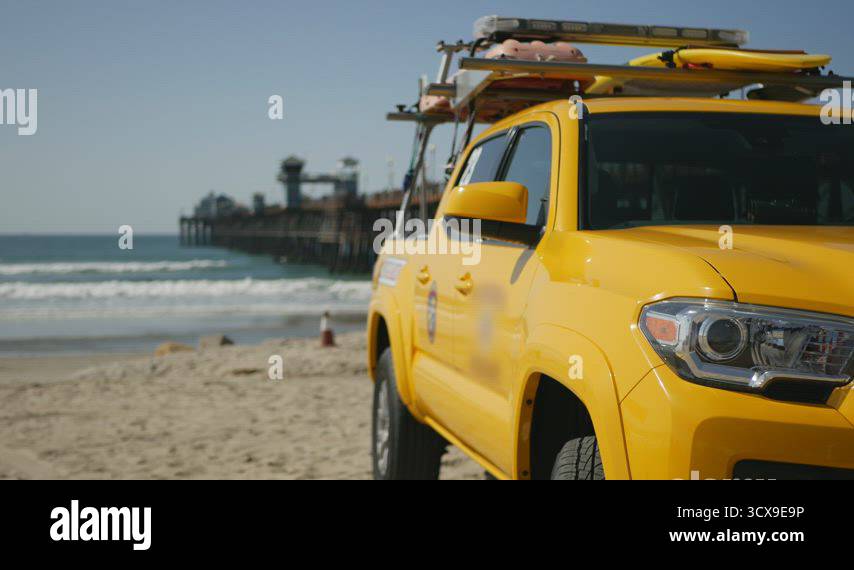Yellow lifeguard car, ocean beach California USA. Rescue pick up truck ...