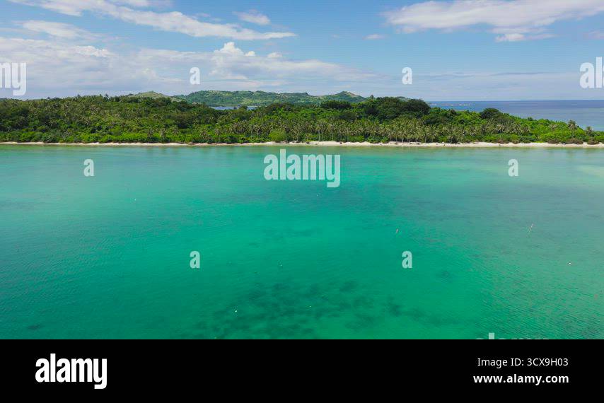 Tropical island with a lagoon and white sandy beach. Caramoan Islands ...