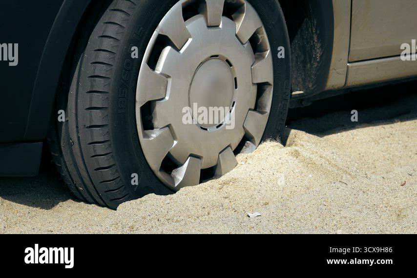 Spinning wheel of a car stuck in the sand on a sea beach Stock Video ...