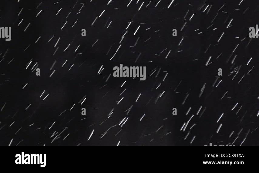 Heavy rain drops on night black background with light. It can be used ...