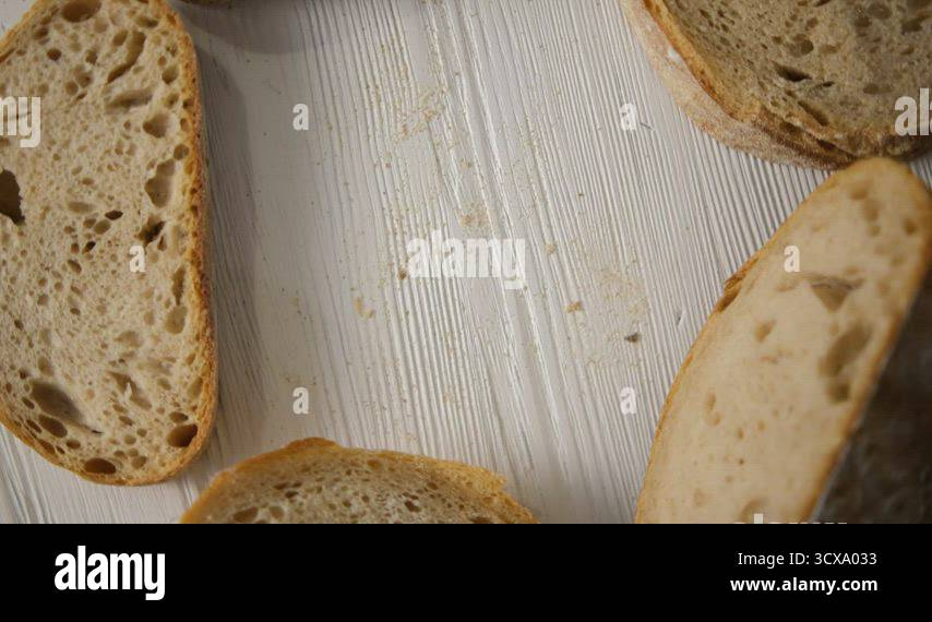 Sliced bread. Whirls of freshly baked bread in the bakery. Wooden table ...