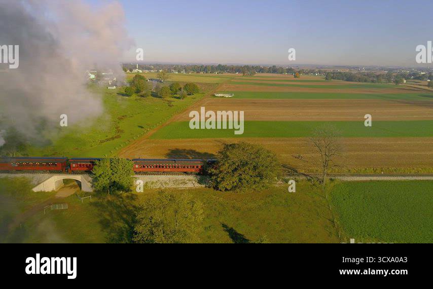 Aerial View of Farmlands at Sunrise with a Steam Engine and Passenger ...