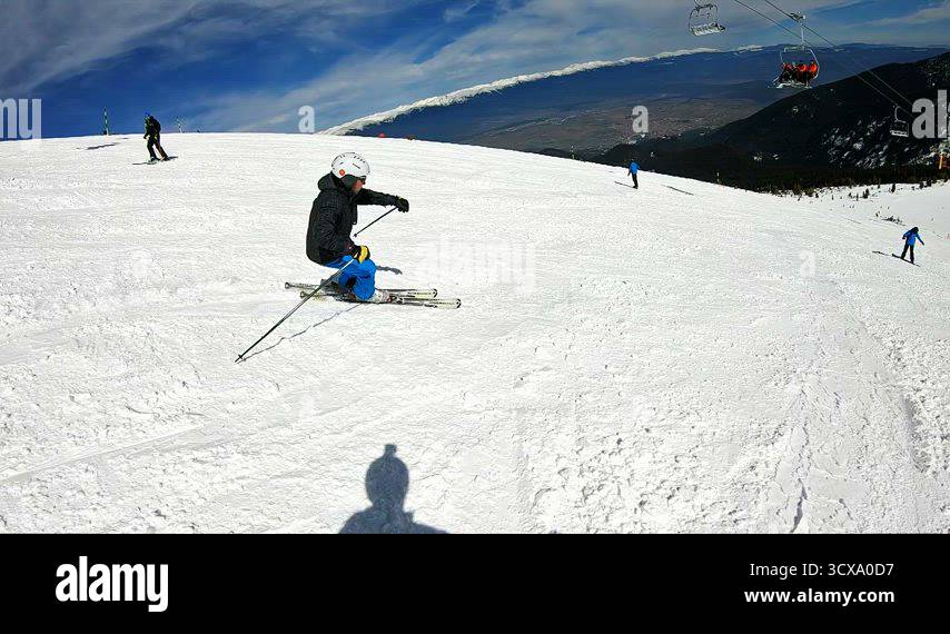 Expert male ski on fresh powder snow on ski slope in Bansko, Bulgaria ...