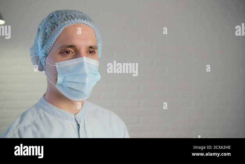 A male doctor wearing a protective mask during a pandemic. A close-up ...