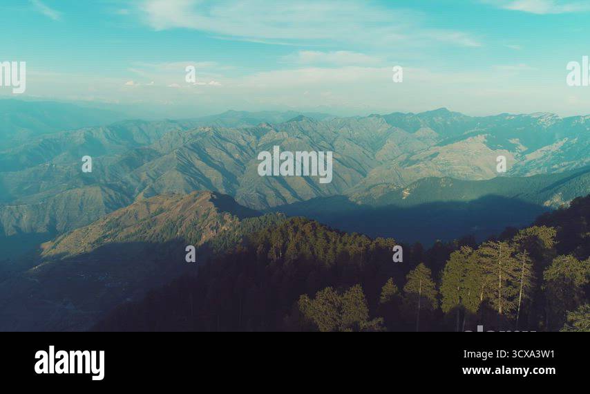 Beautiful aerial Mountain range view against the cloudy blue sky ...