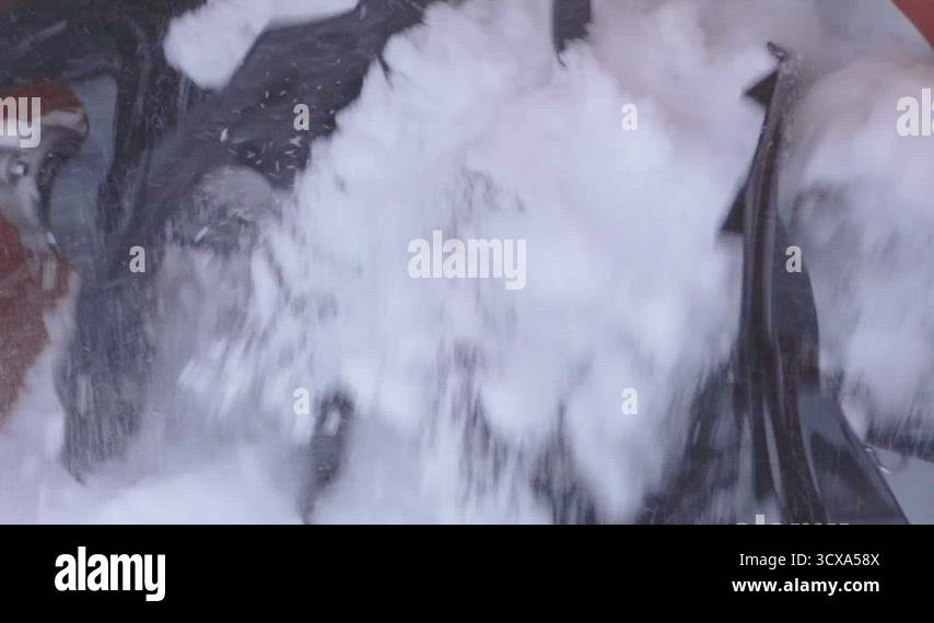 Spectacular slow-motion video of a snow blower. Snow sucking in with ...