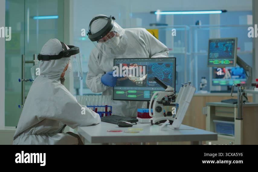 Scientist team in prorection suit arguing in front of pc looking at ...
