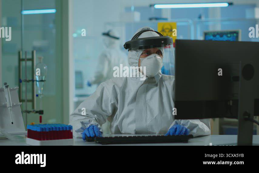 Laboratory technician assistant in ppe suit analyzing blood sample ...