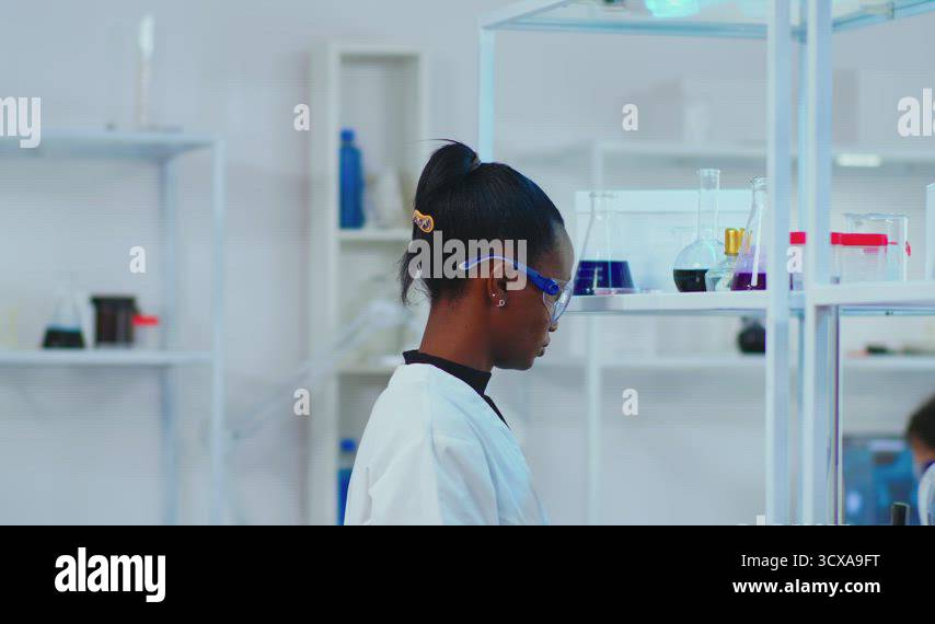 African woman chemist researcher using glass equipment in lab Stock ...