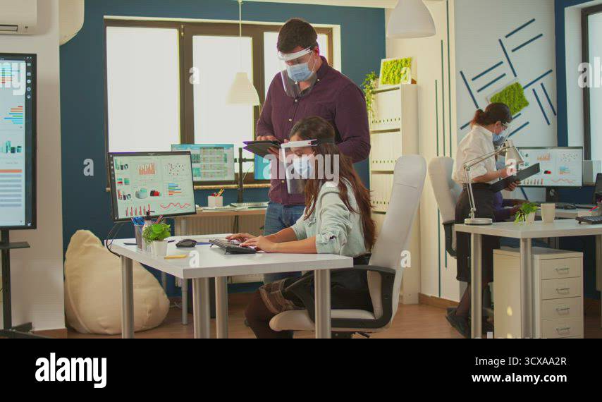 Coworkers with protection face masks working together Stock Video ...