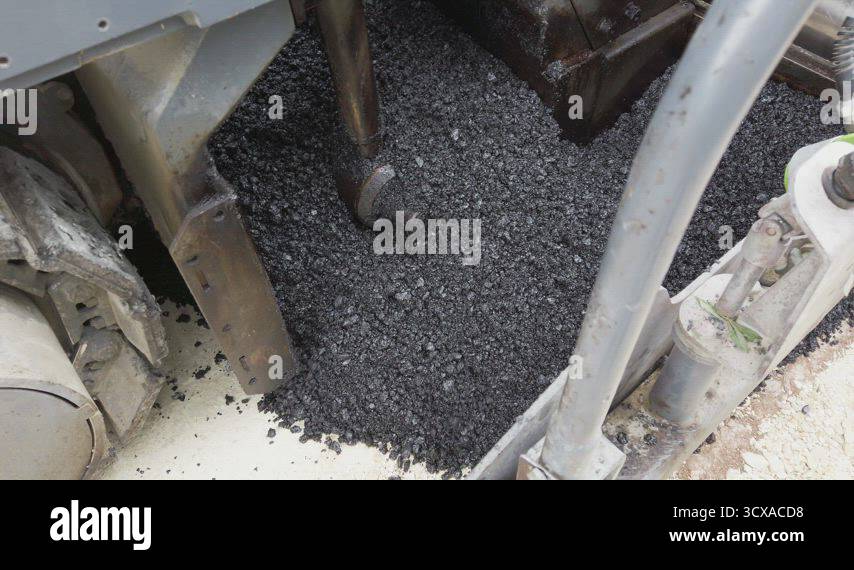 Road construction. Asphalt pavement machine making new layer of asphalt ...