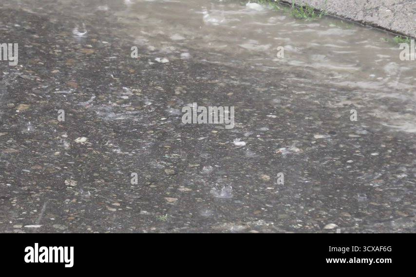 Rain storm. Heavy rain drops splash on asphalt road Stock Video Footage ...