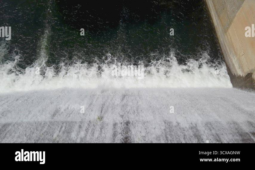 Darinage on a dam, water flows after heavy rain in spring, global ...