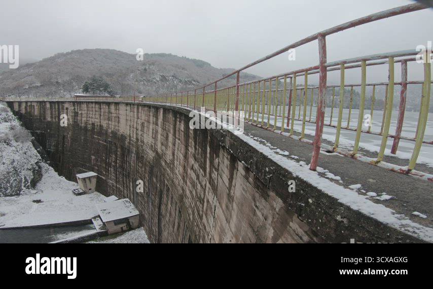 Winter scene of industrial dam with frozen lake water Stock Video ...