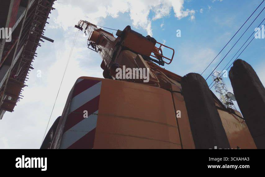 Industrial Crane operating and lifting an electric generator against ...