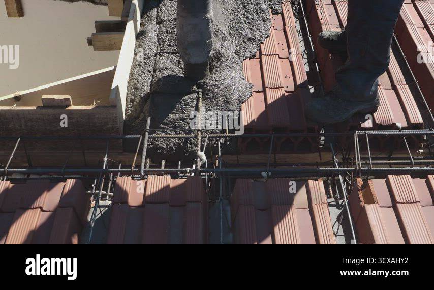 construction workers working on steel tie for the second floor beam of ...