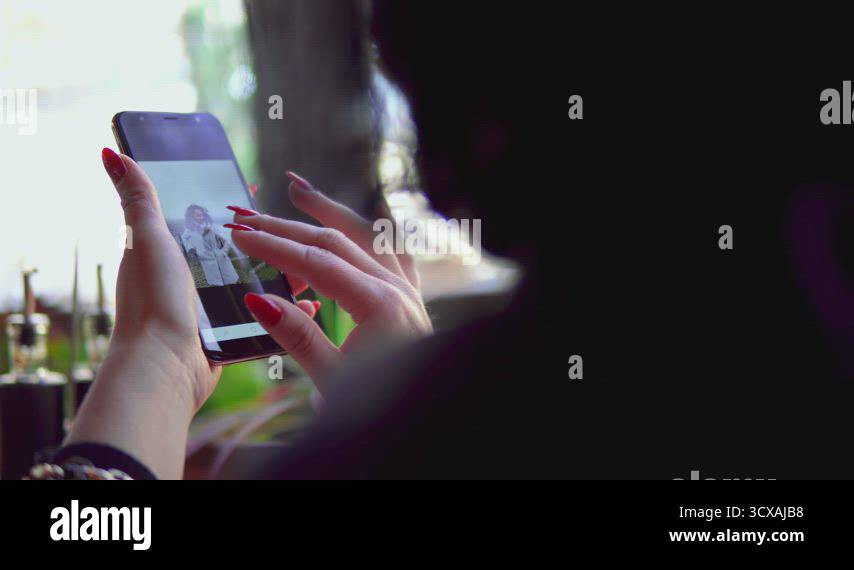 Woman scroll picture gallery on smartphone and look at photos from her ...