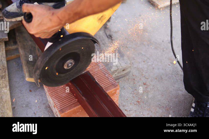 Worker Cutting Metal With Grinder. Sparks While Grinding Iron Stock ...