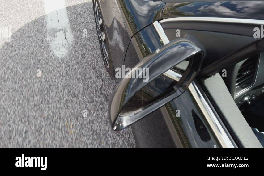 Driving in car down highway with view from above off mirrorr, turning ...