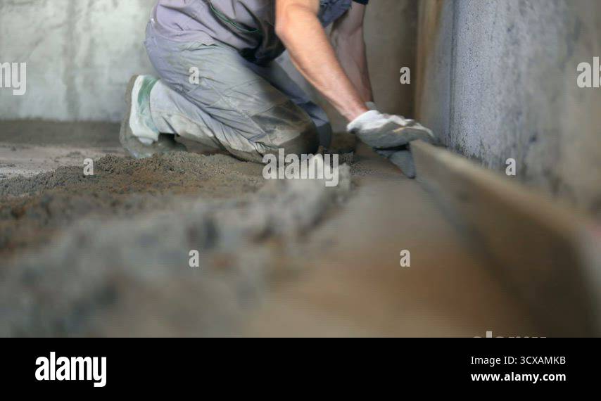 Tool for smooth concrete surface. Worker with tool makes a smooth ...