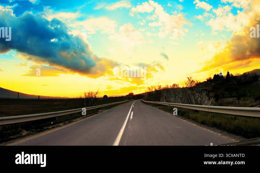 Sport car driving fast on road with sunset vibrant sky Stock Video ...