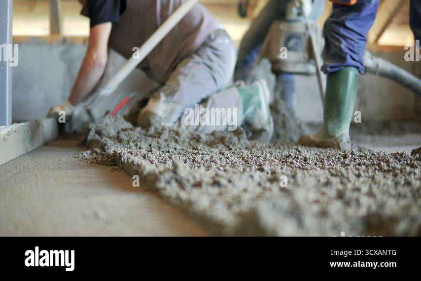 Trowel working to smooth concrete ground. Concrete Floor Levelling ...