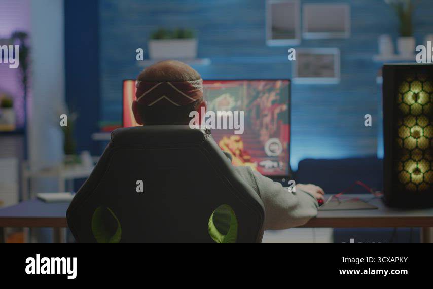 Back view of pro gamer testing new graphics of FPS videogame Stock ...
