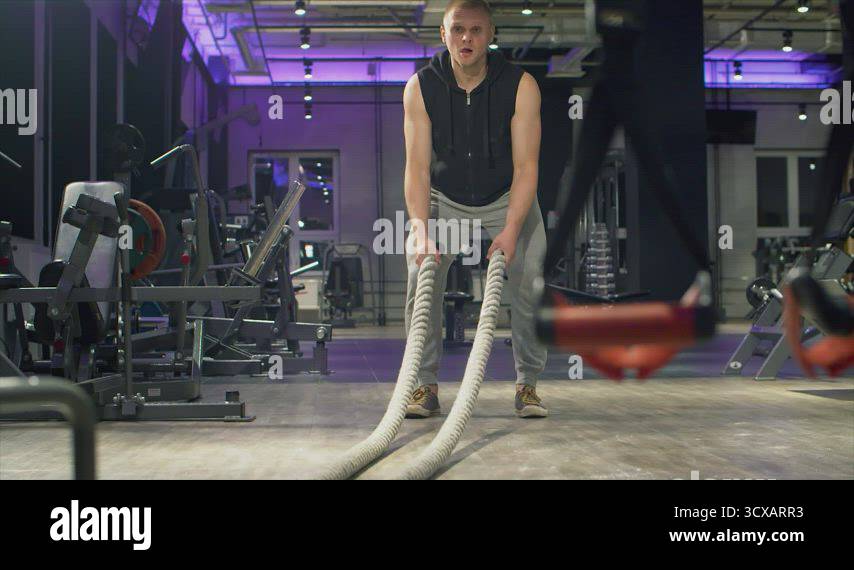 Man bodybuilder doing exercise using battle ropes Stock Video Footage ...