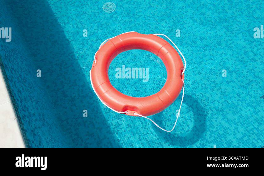 Safety equipment, Life buoy or rescue buoy floating on swimming pool to ...